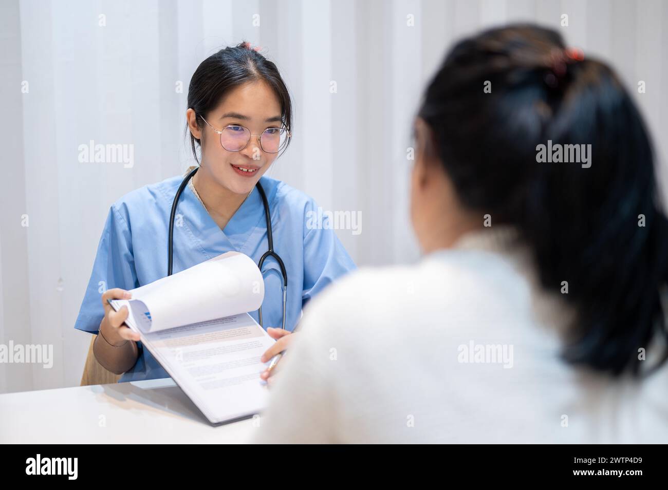 Experienced doctor talking nurse showing hi-res stock photography and ...