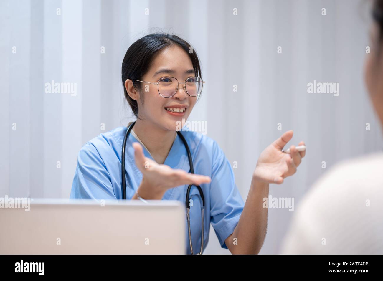 A professional and confident Asian female doctor consulting the ...