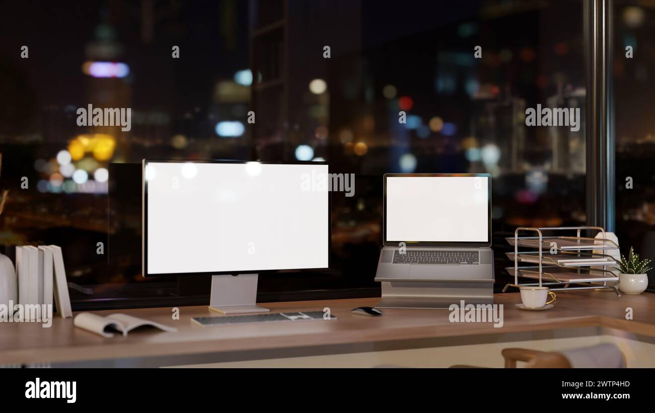 A modern office at night features a white-screen PC computer and laptop ...