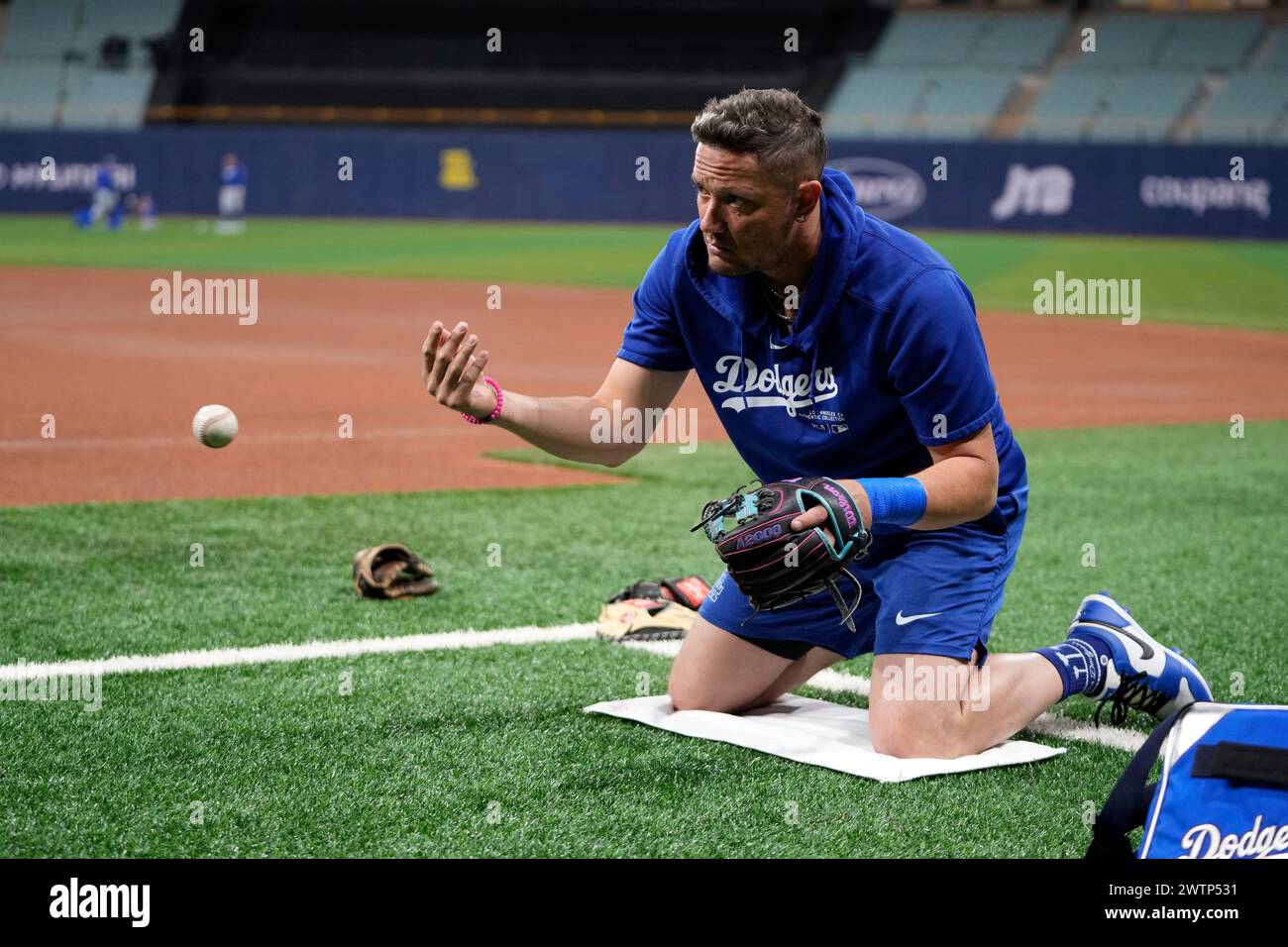 Los Angeles Dodgers' Miguel Rojas tosses a ball during a baseball ...