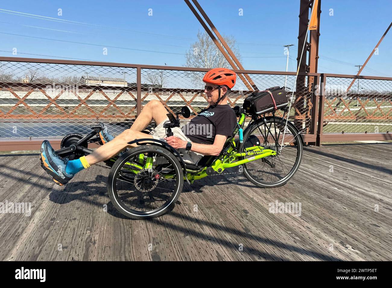 Leo Robinson, 86, cycles across the Kitselman bridge connecting the ...