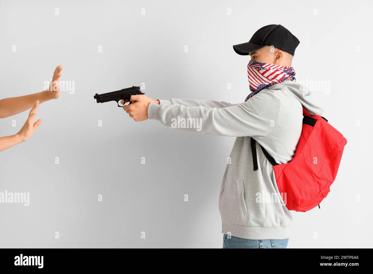Male student threatening with gun on light background. School shooting ...