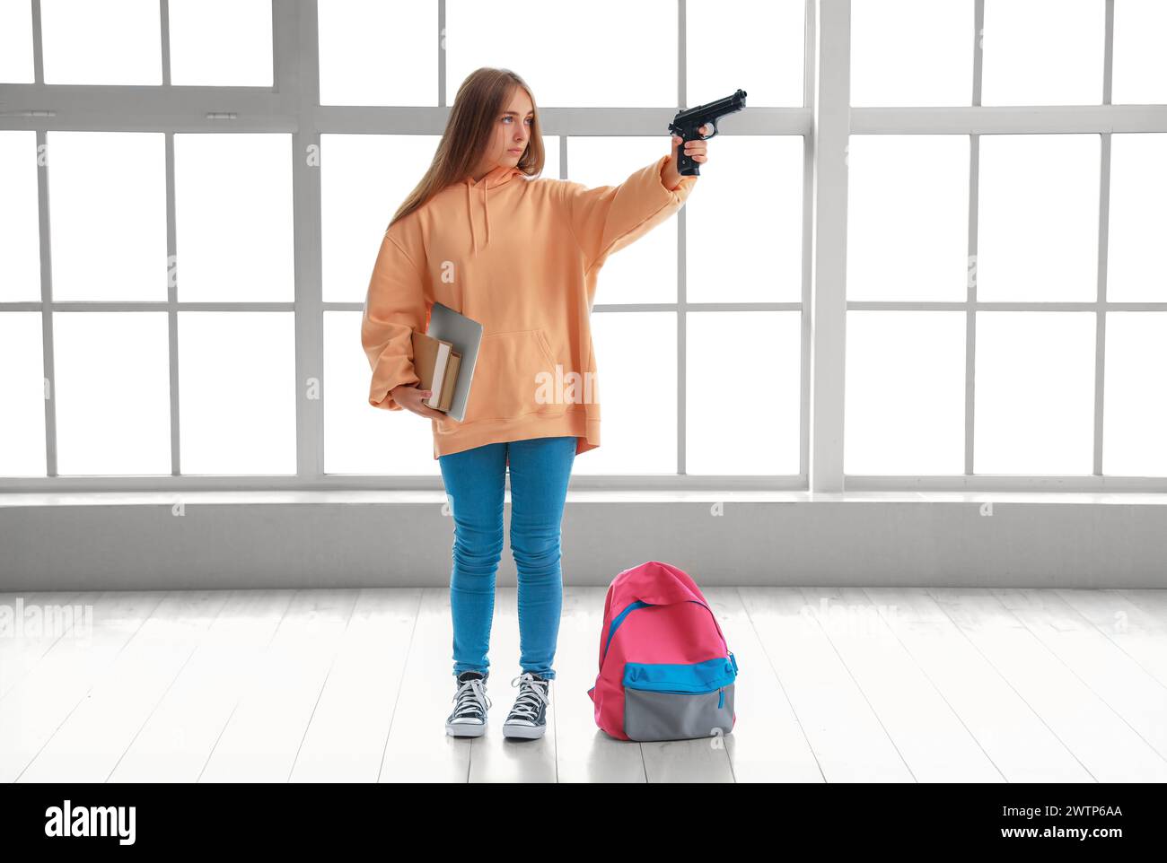 Female student with gun at school Stock Photo - Alamy