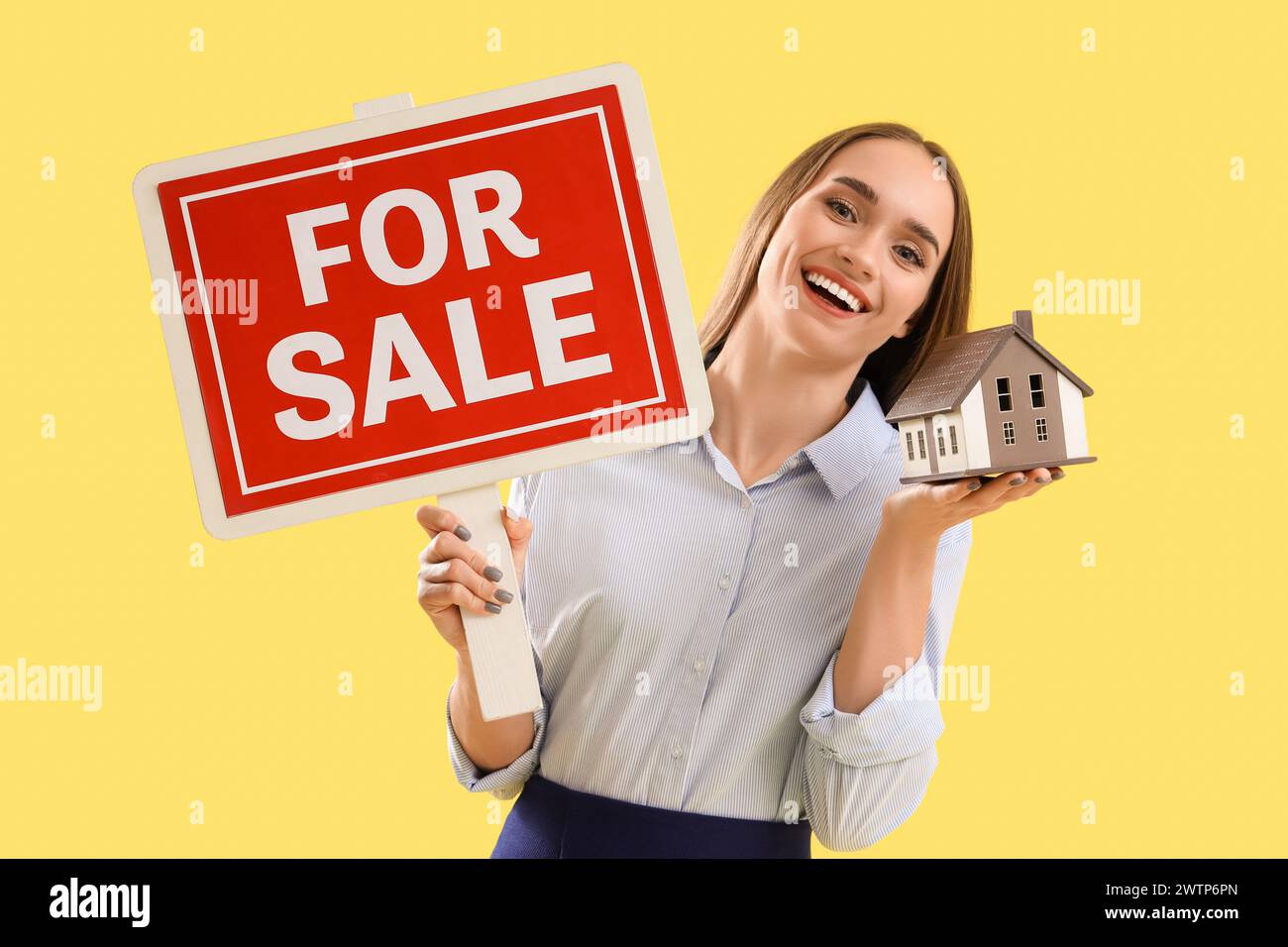 Portrait of female real estate agent with house model and FOR SALE sign ...