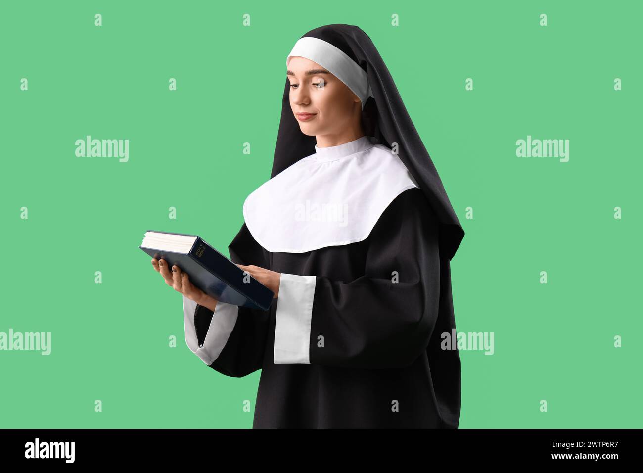 Portrait of nun with holy Bible on green background Stock Photo - Alamy