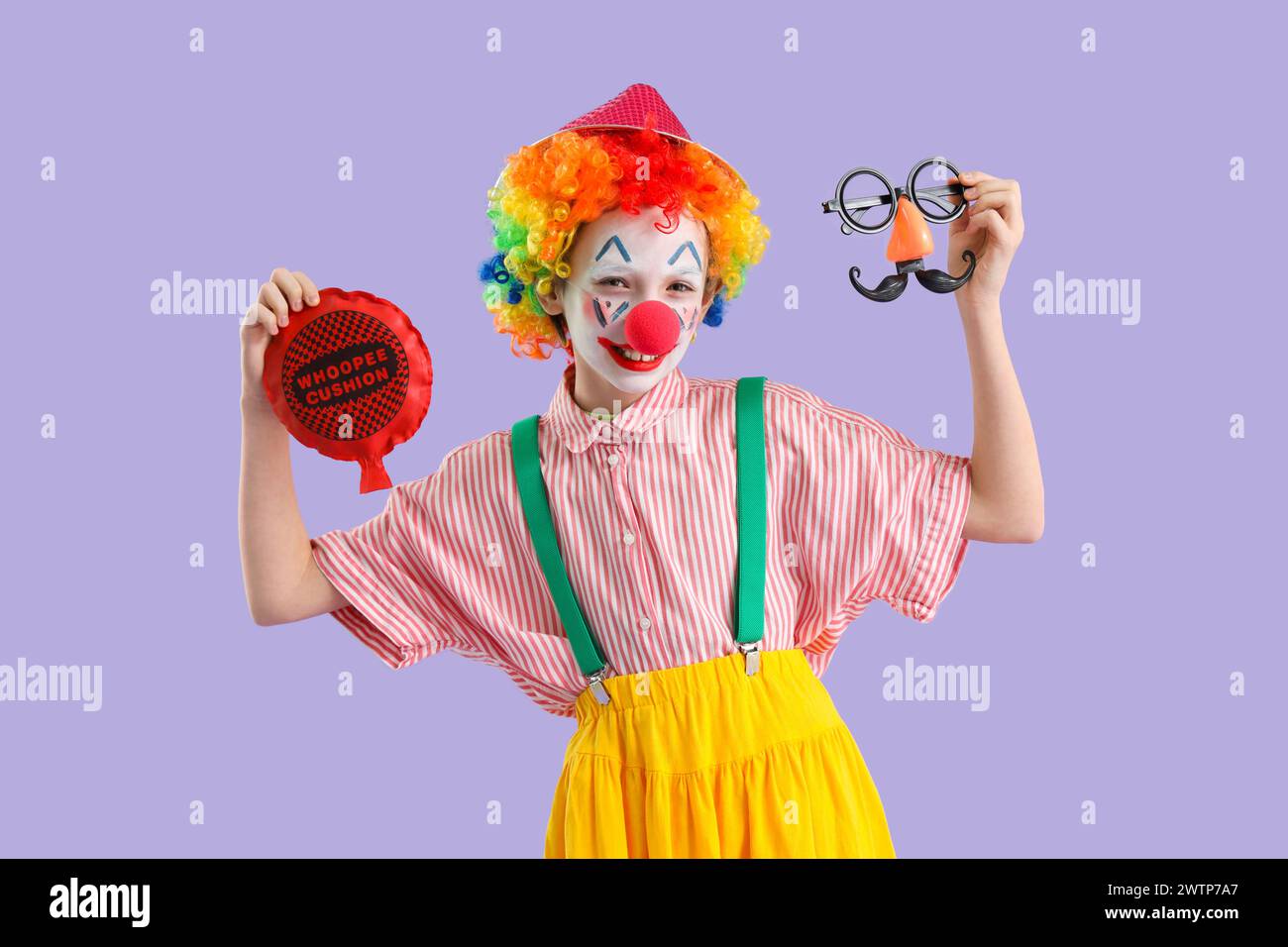 Funny little girl dressed as clown with disguise and whoopee cushion on ...
