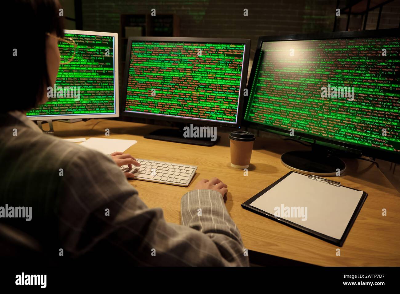 Female programmer working with computer in office at night Stock Photo ...