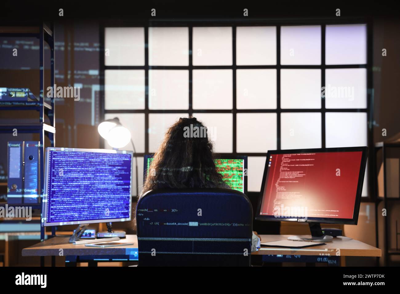 Female African-American programmer working with computer monitors in ...