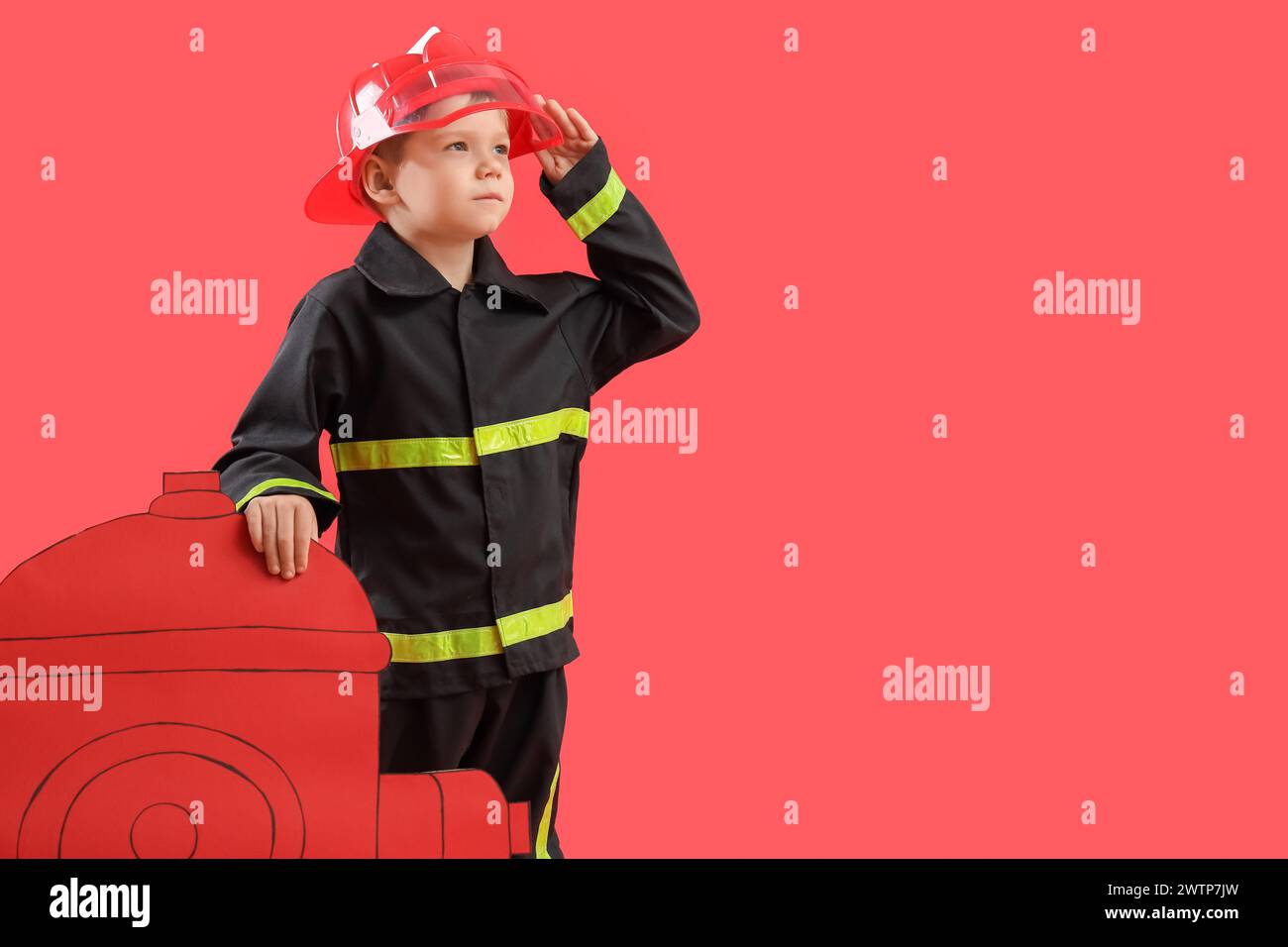Cute little firefighter with paper hydrant on red background Stock ...