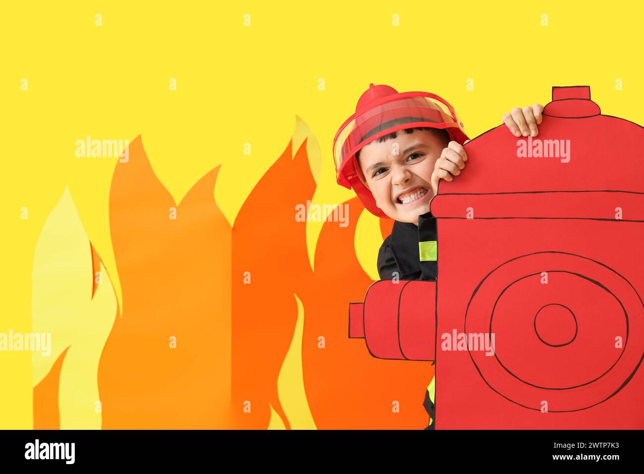 Cute little firefighter with paper hydrant and flame on yellow ...