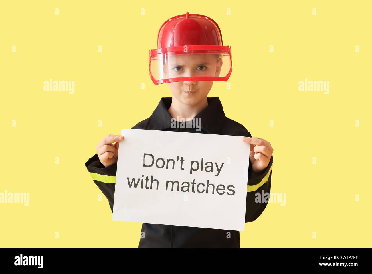 Cute little firefighter holding paper with text DON'T PLAY WITH MATCHES ...