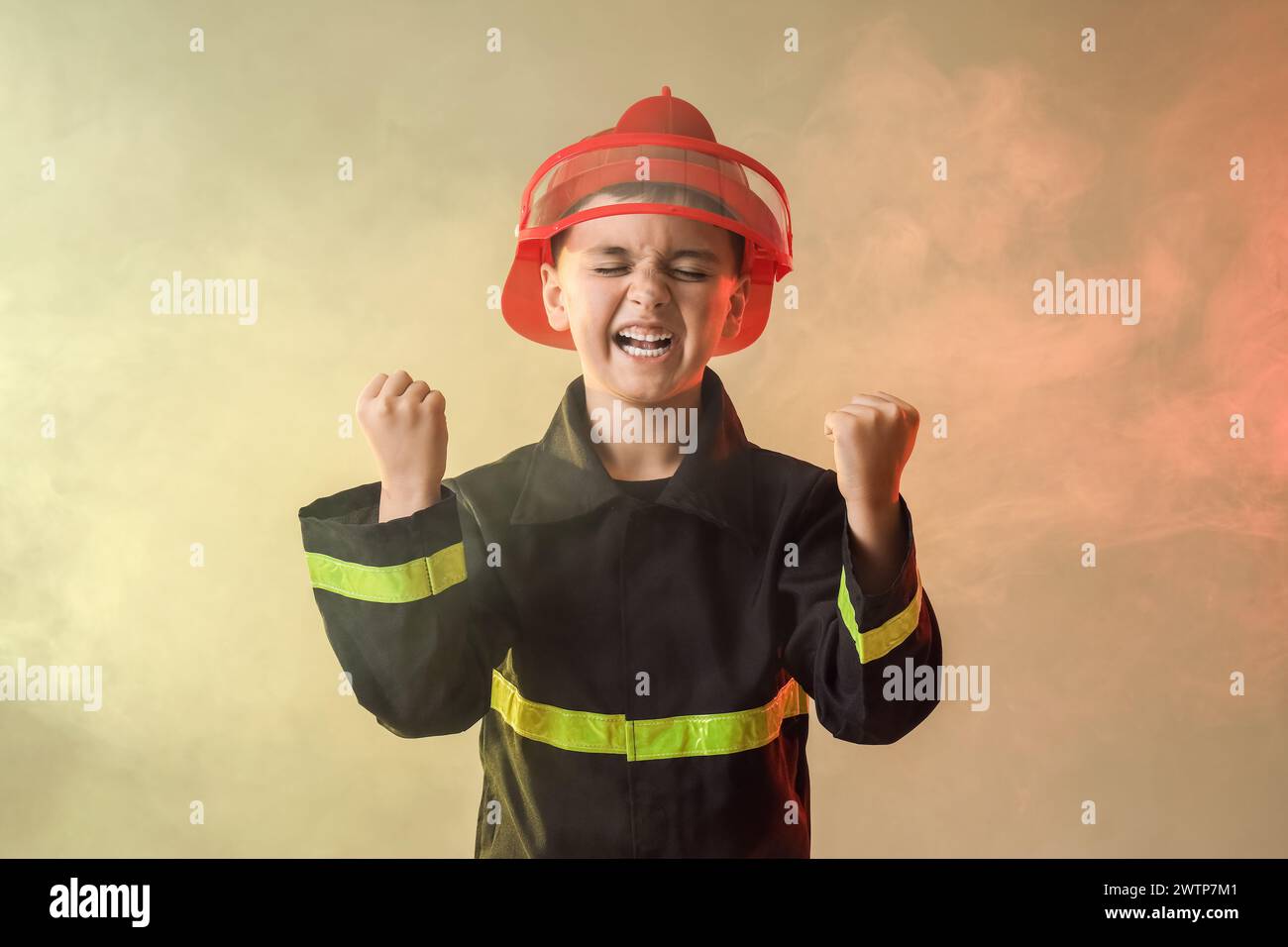 Angry little firefighter in smoke on grey background Stock Photo - Alamy