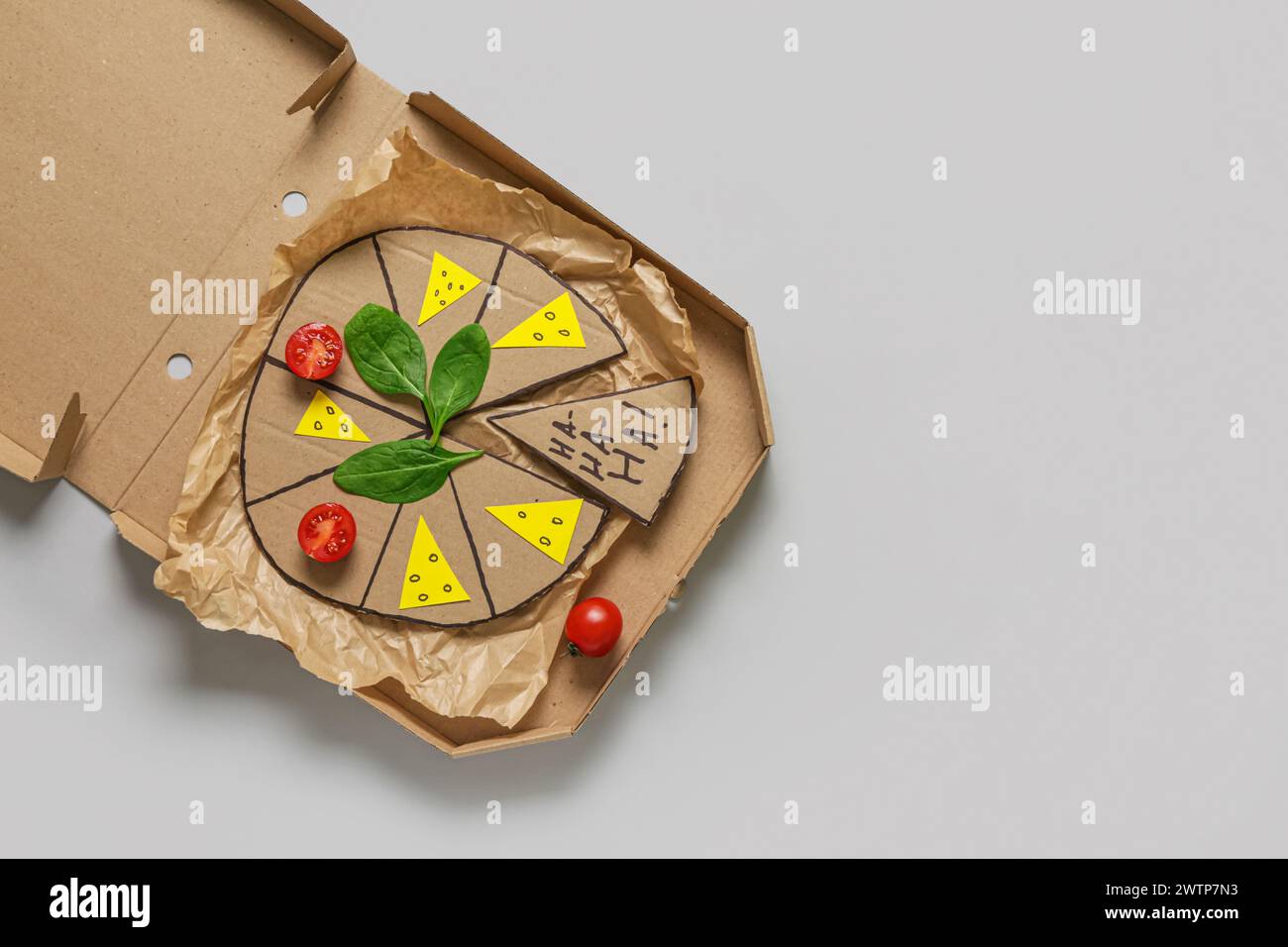 Carton pizza with tomatoes and basil on white background. April Fools ...