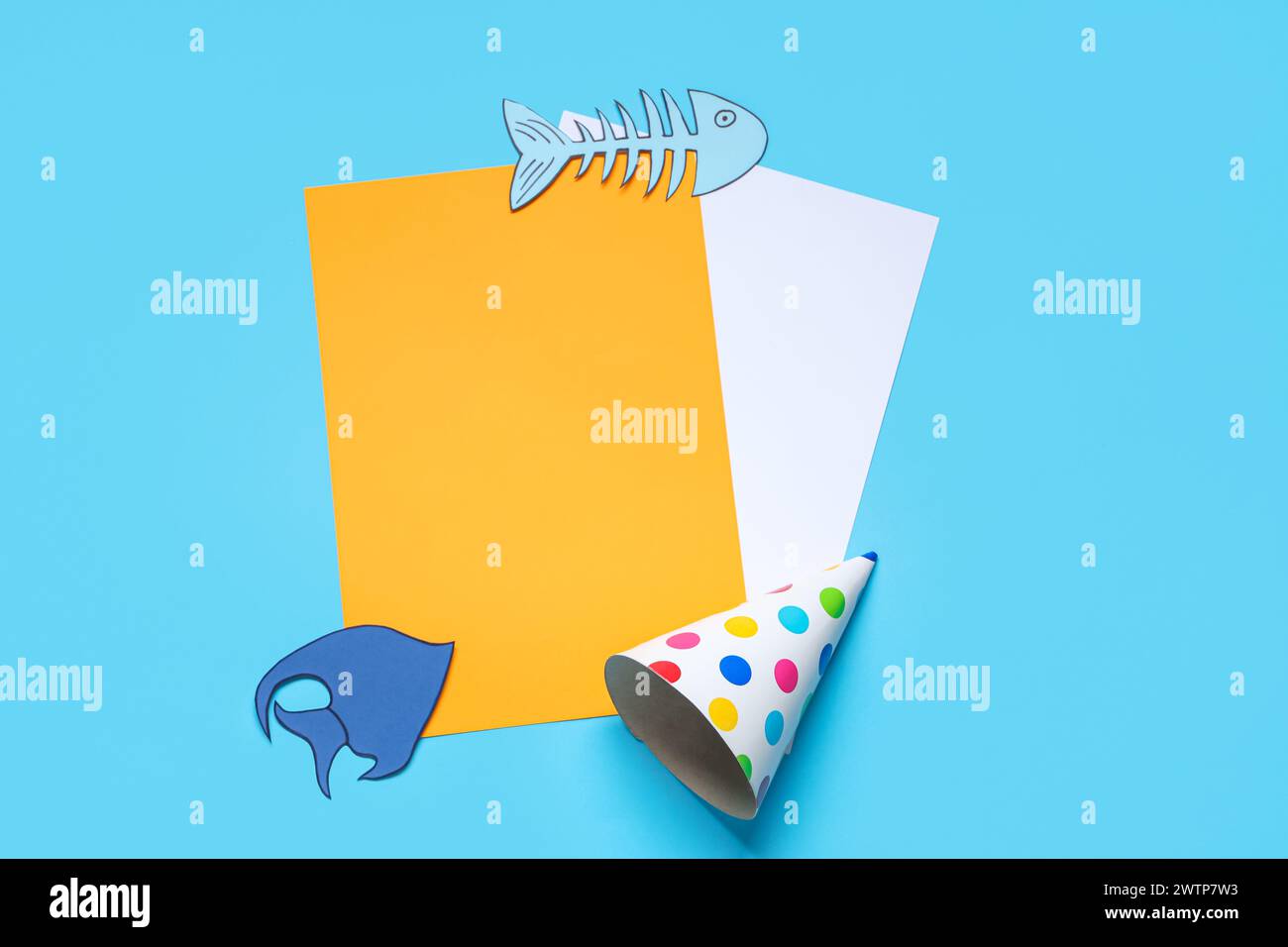 Blank card with paper fishes and party hat on blue background. April ...