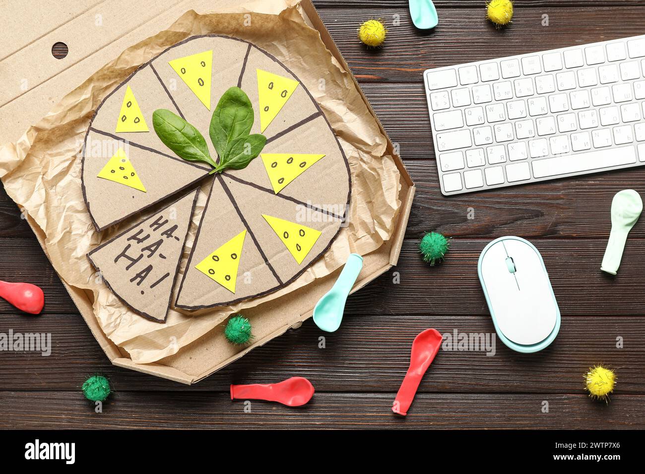 Carton pizza, computer keyboard and mouse on wooden background. April ...