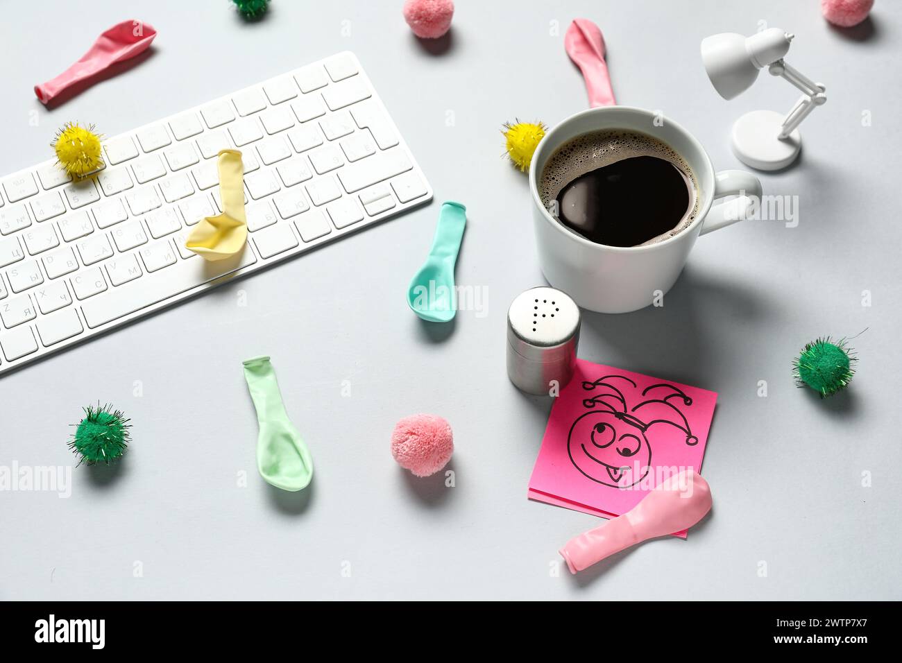 Computer keyboard, sticky note, salt and cup of coffee on white ...