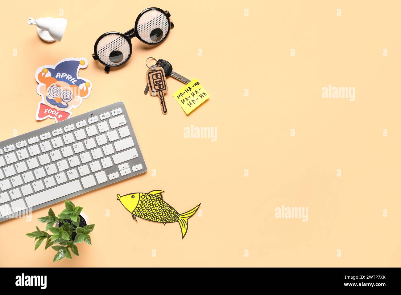 Carton key, sticky note and computer keyboard on beige background ...