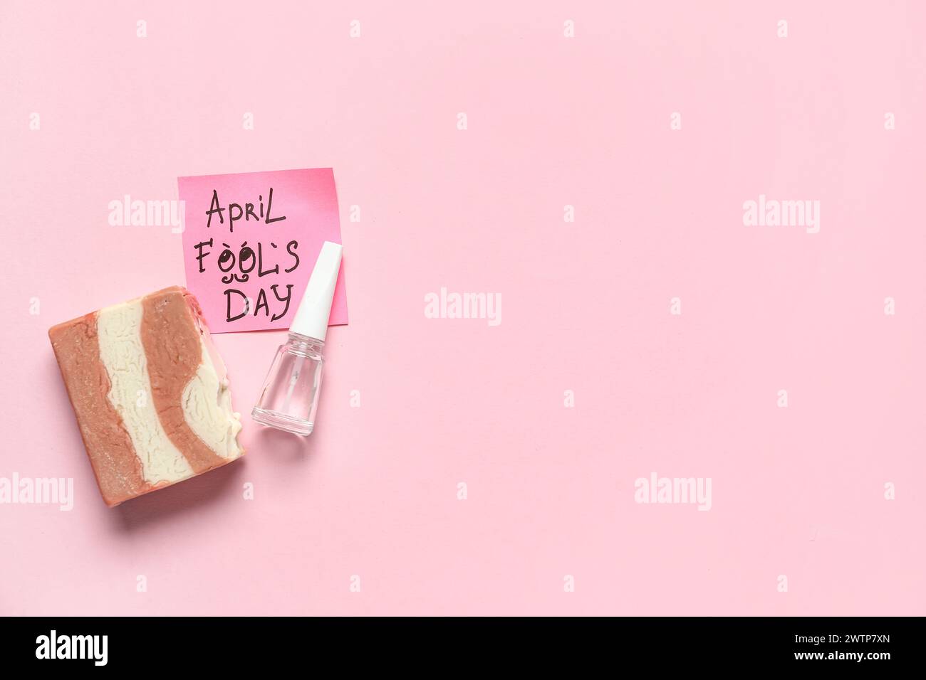 Nail polish, soap and sticky note on pink background. April Fools Day ...