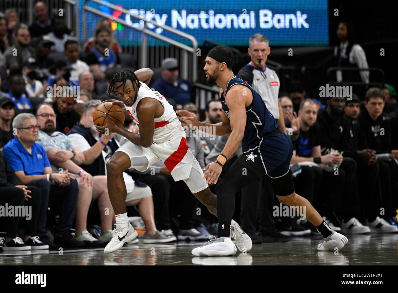 Toronto Raptors guard Immanuel Quickley, left, is defended by Orlando ...