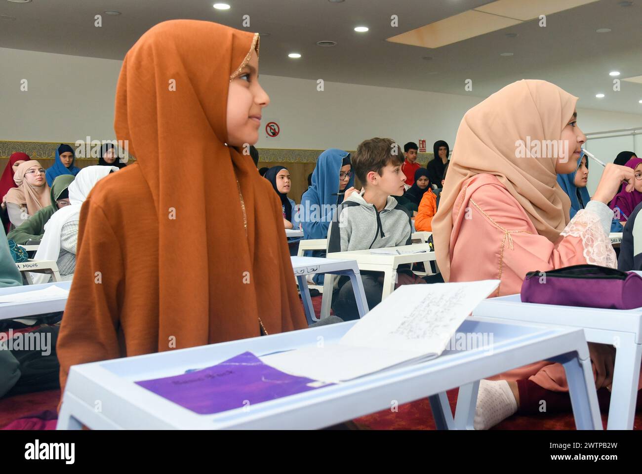 Young students wearing Islamic veils attend an Arabic class lesson at ...