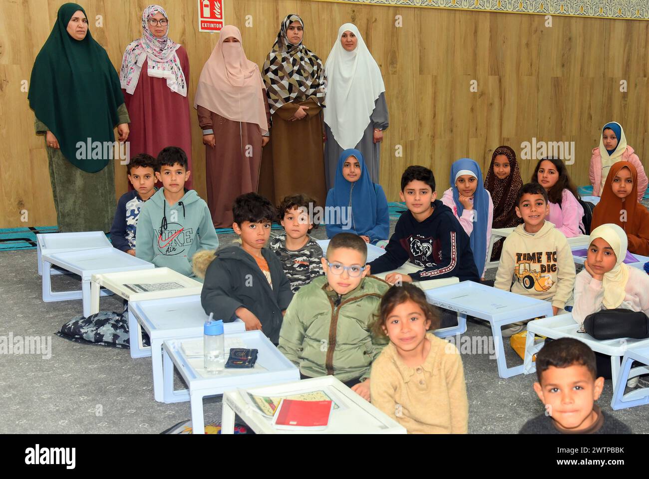 Women wearing Islamic veils seen with part of their students during an ...