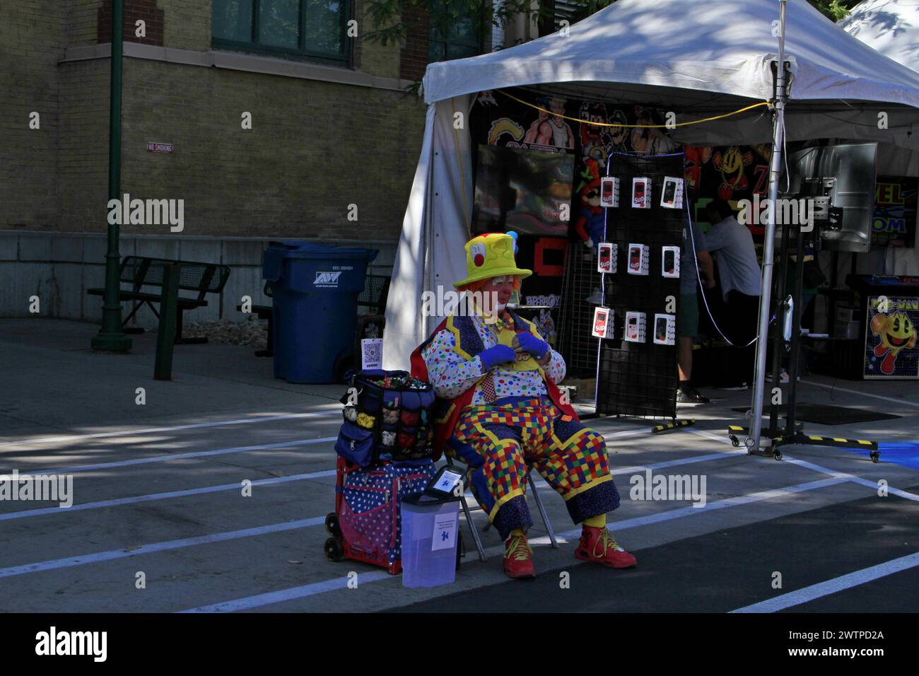 Utah State Fair Clown sitting in a chair by a Vendor Tent Stock Photo ...