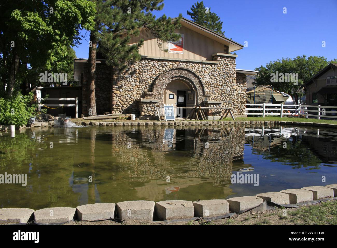 Water Reflection with trees and blue sky and building at Utah State ...