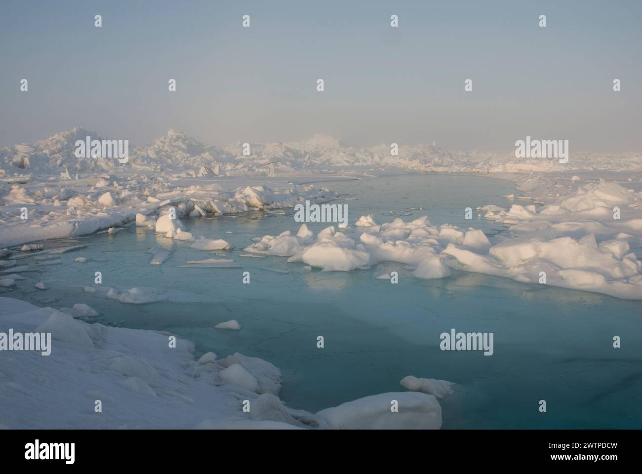 Seascape of rough pack ice over the Chukchi sea in springtime, off shore from the arctic village ...