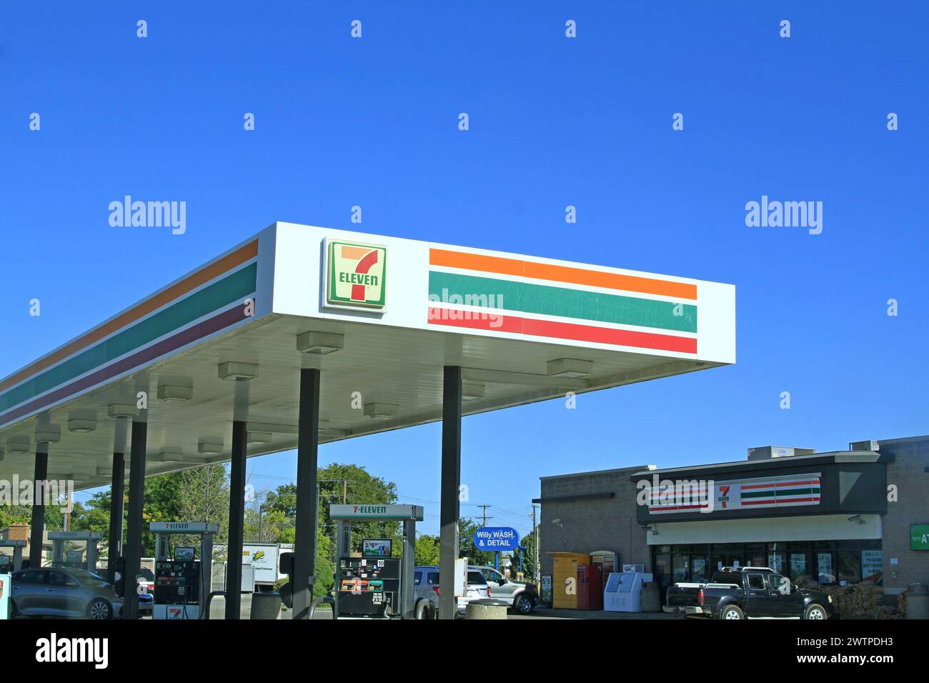SEVEN ELEVEN advertisement sign with blue sky outdoor at a gas station ...