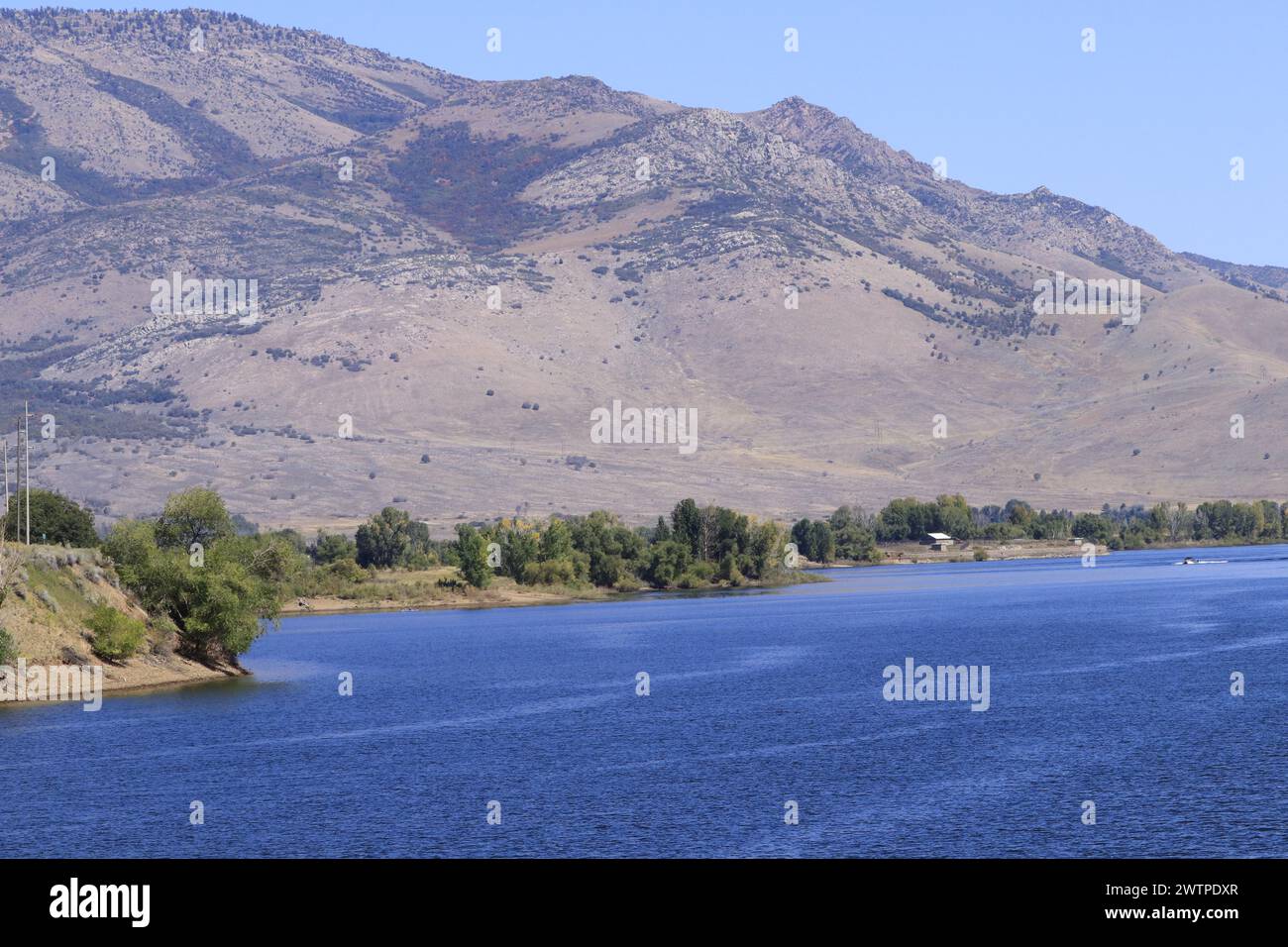 Echoe Reservoir in the early fall with trees and the Mountains with ...