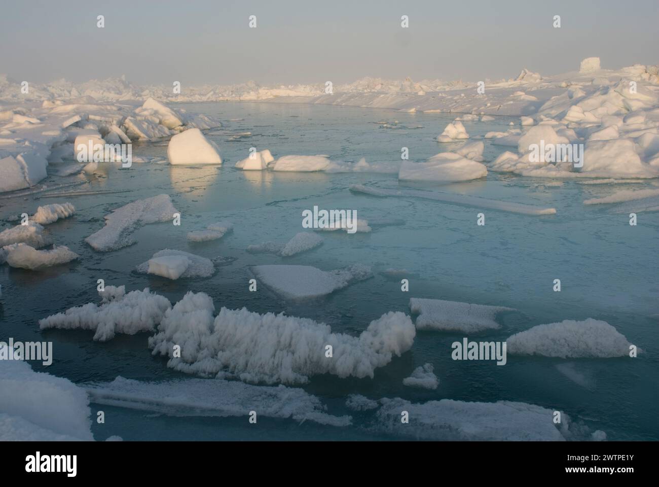 Seascape of rough pack ice over the Chukchi sea in springtime, off shore from the arctic village ...