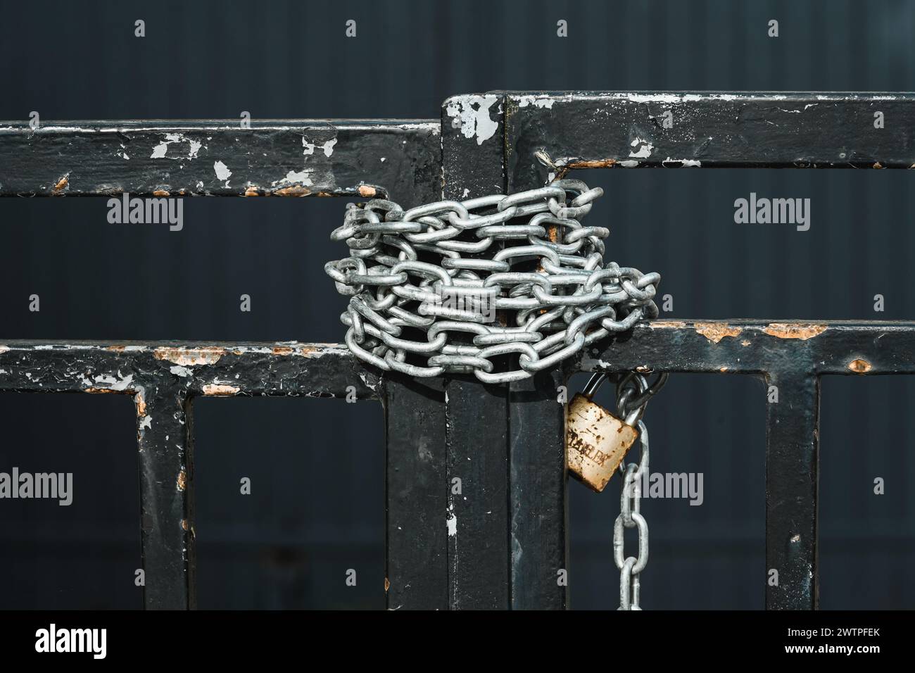 Chain wrapped around a gate and locked with a padlock Stock Photo - Alamy