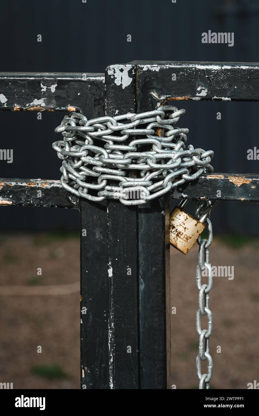 Chain wrapped around a gate and locked with a padlock Stock Photo - Alamy