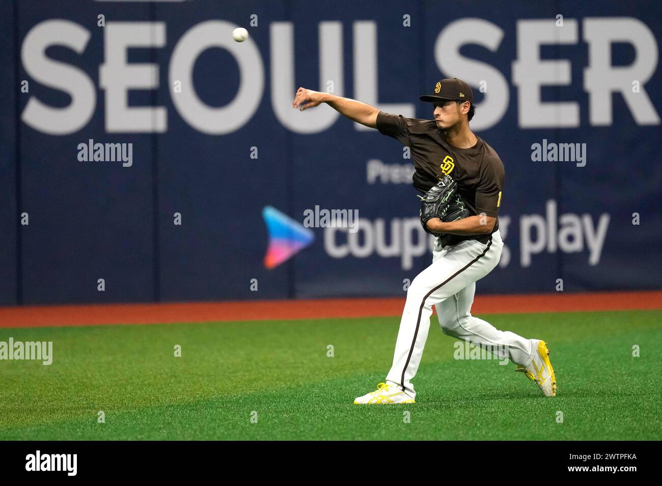 San Diego Padres' pitcher Yu Darvish warms up during a baseball workout ...