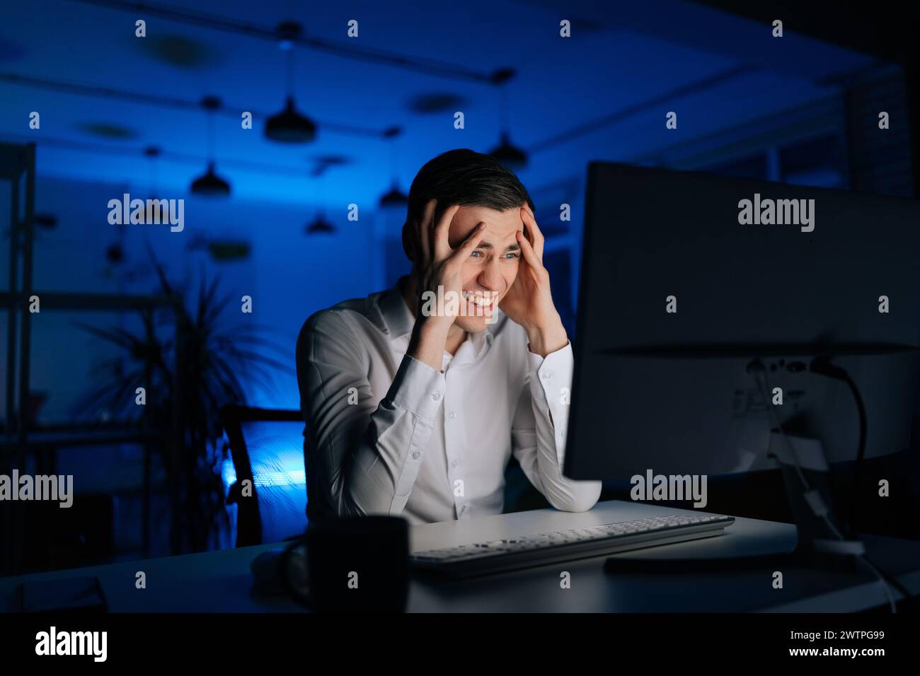 Excited stressed young man shouting with frustrated and furious working ...