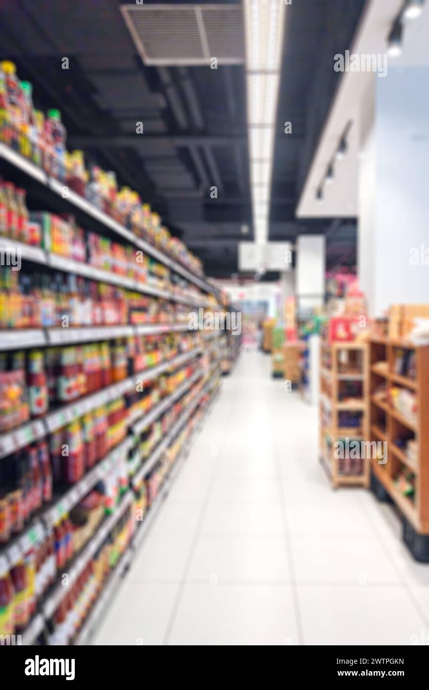 Supermarket aisle, shelves with products. Blurred or defocused for ...
