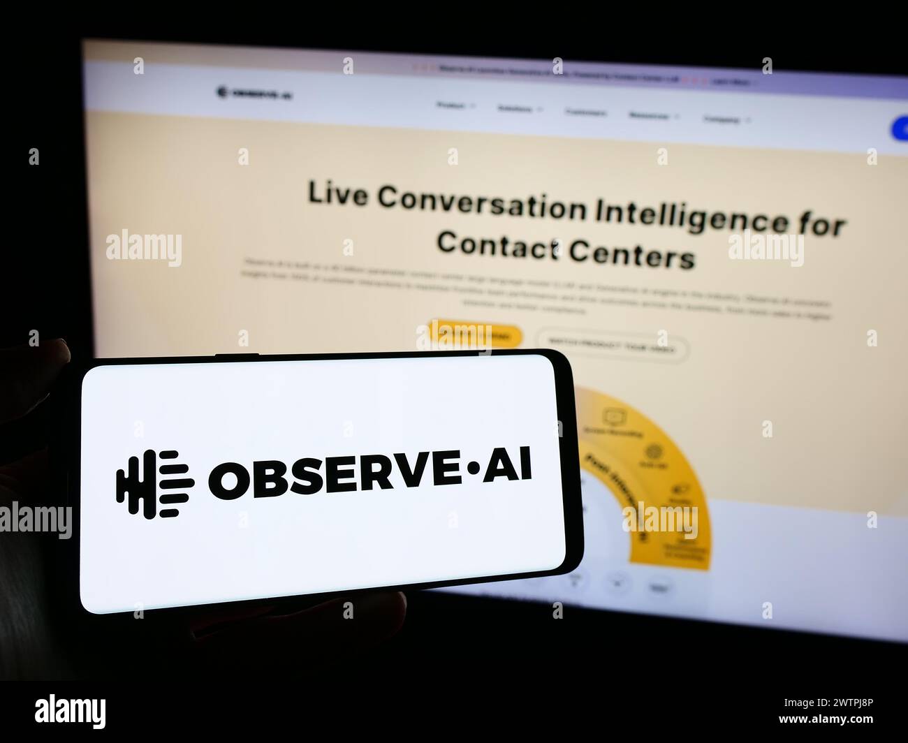 Person holding mobile phone with logo of artificial intelligence ...