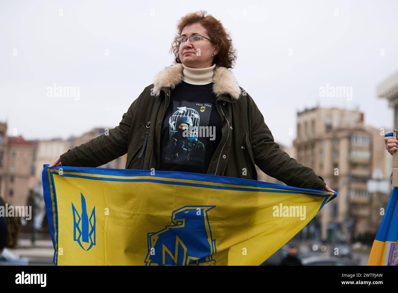 Ukrainian woman holds a flag of Azov brigade on a public demonstration ...
