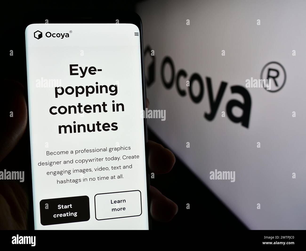 Person holding smartphone with web page of Lithuanian artificial intelligence company Ocoya in ...