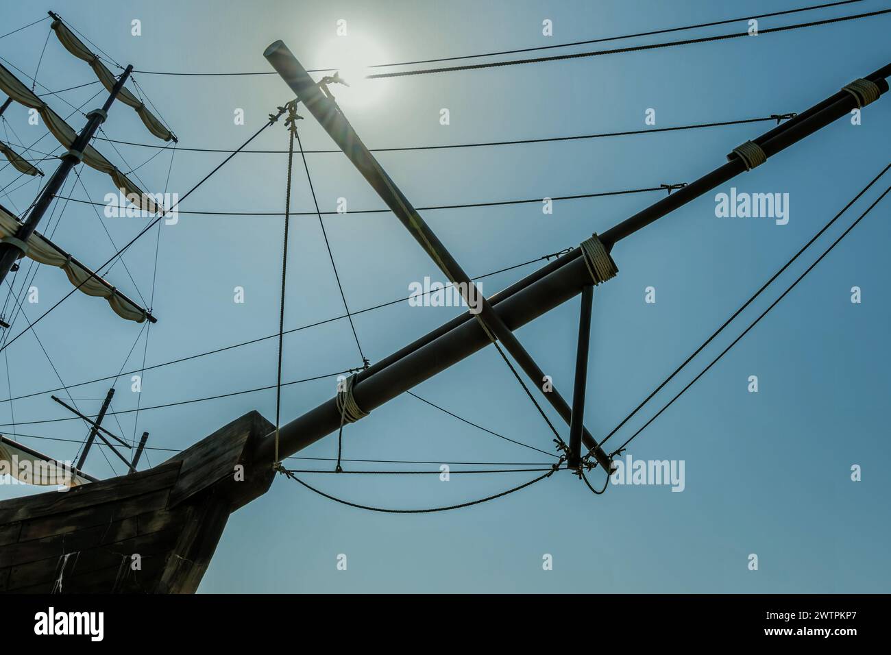 Bow and rigging of a replica of British ship Lyra with sun overhead in ...