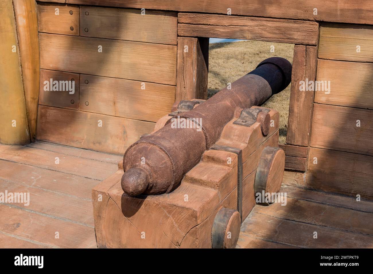 Canon barrel protruding from side of replica of 14th century British ...