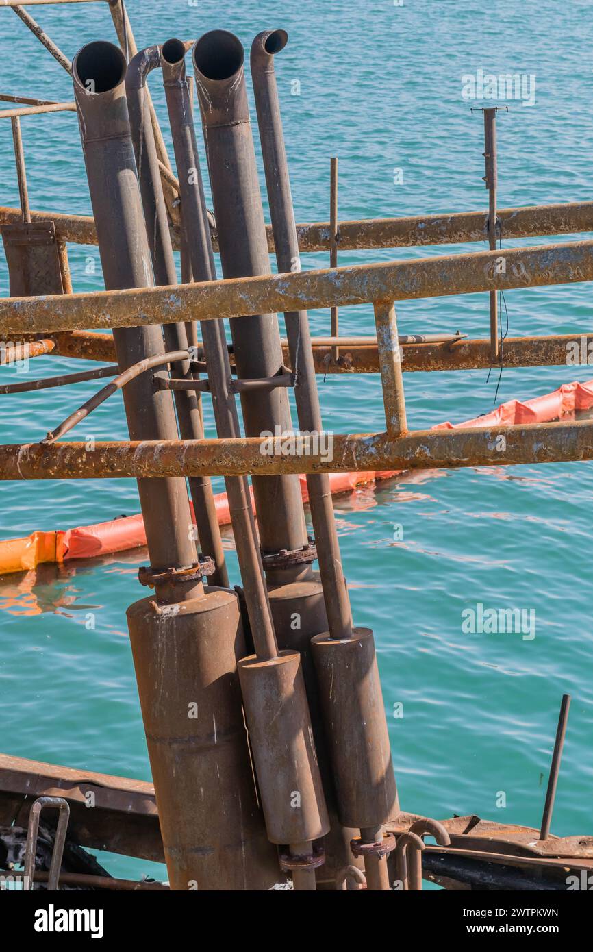 Sunken ship details showing rusted structural booms and submerged pipes ...