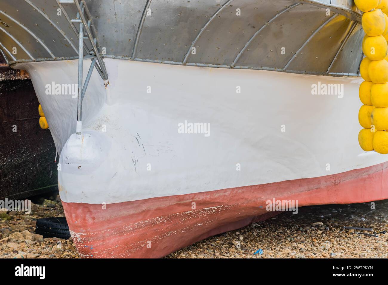 Side view of a boat's hull with yellow buoys, on dry land, in Sinjin-do ...