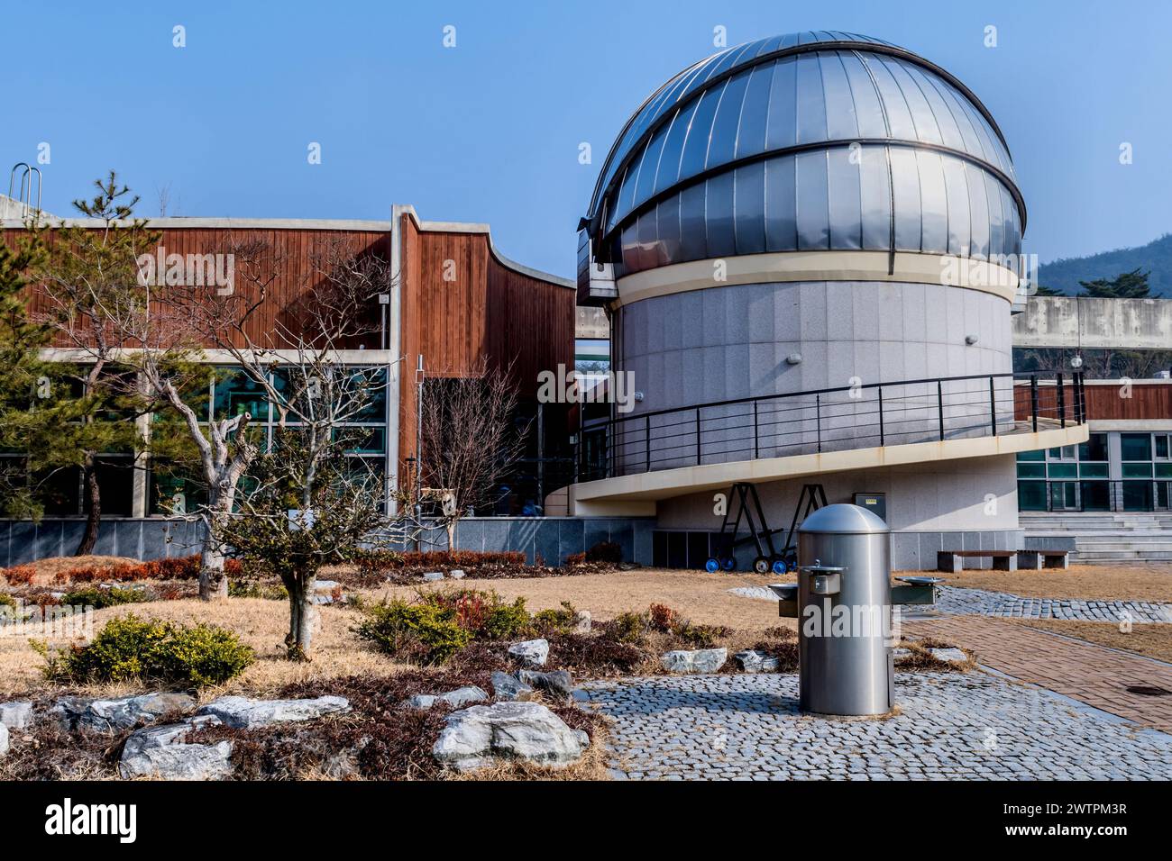Modern observatory building against a clear blue sky during the daytime ...