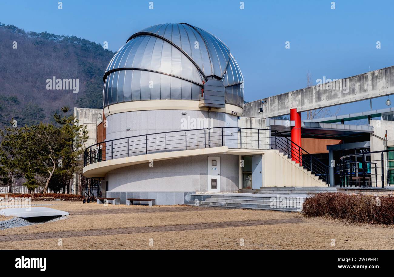 A modern observatory building against a clear blue sky, in South Korea ...