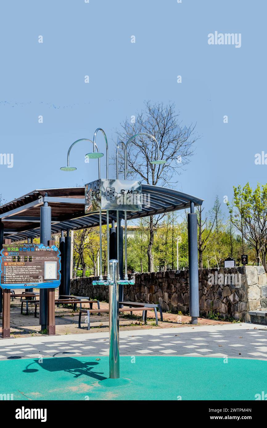 Outdoor shower station in a park with blue skies and nearby ...