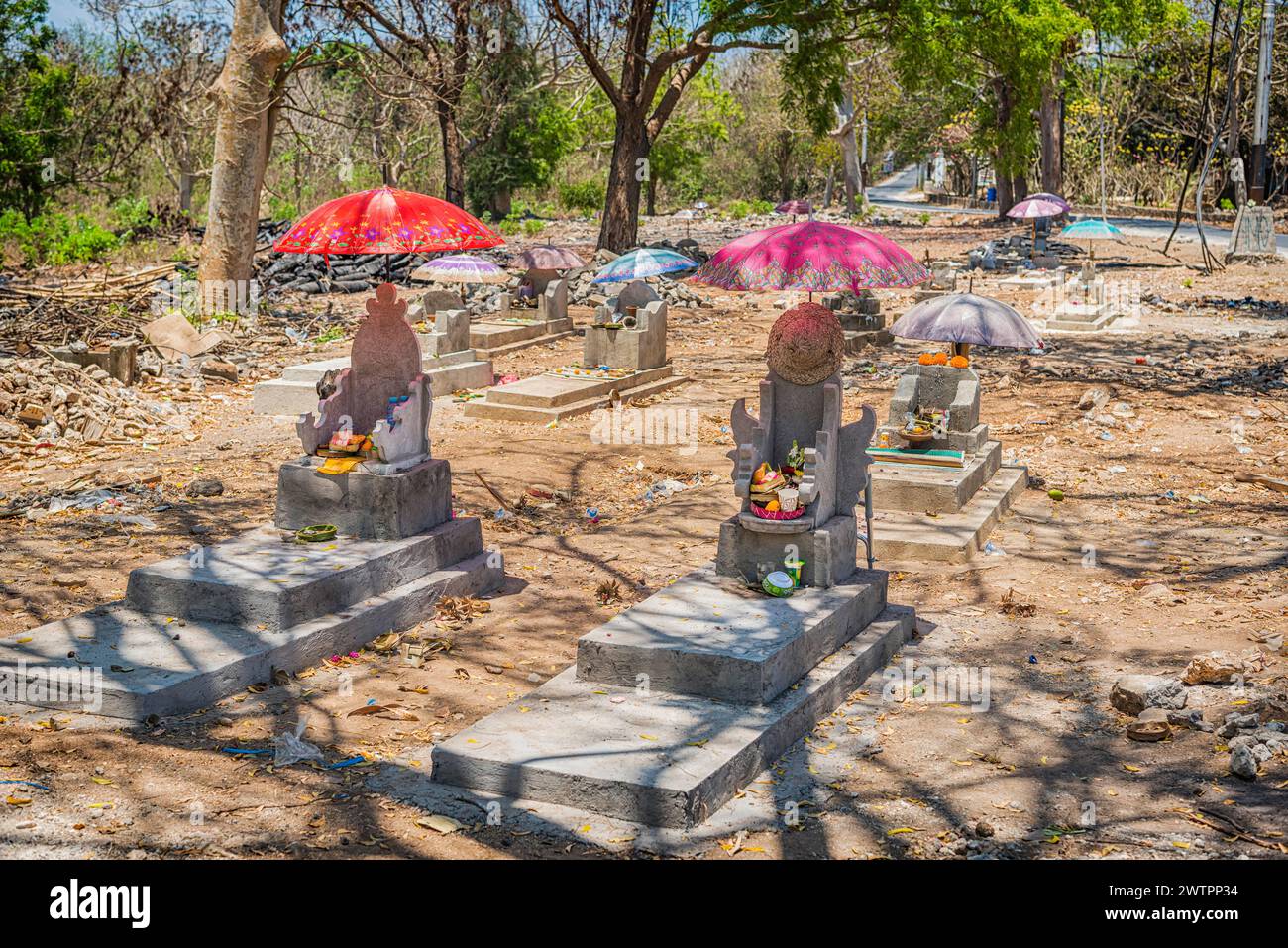 Grave in a cemetery with umbrella and offerings, Hindu, Hindu, world ...