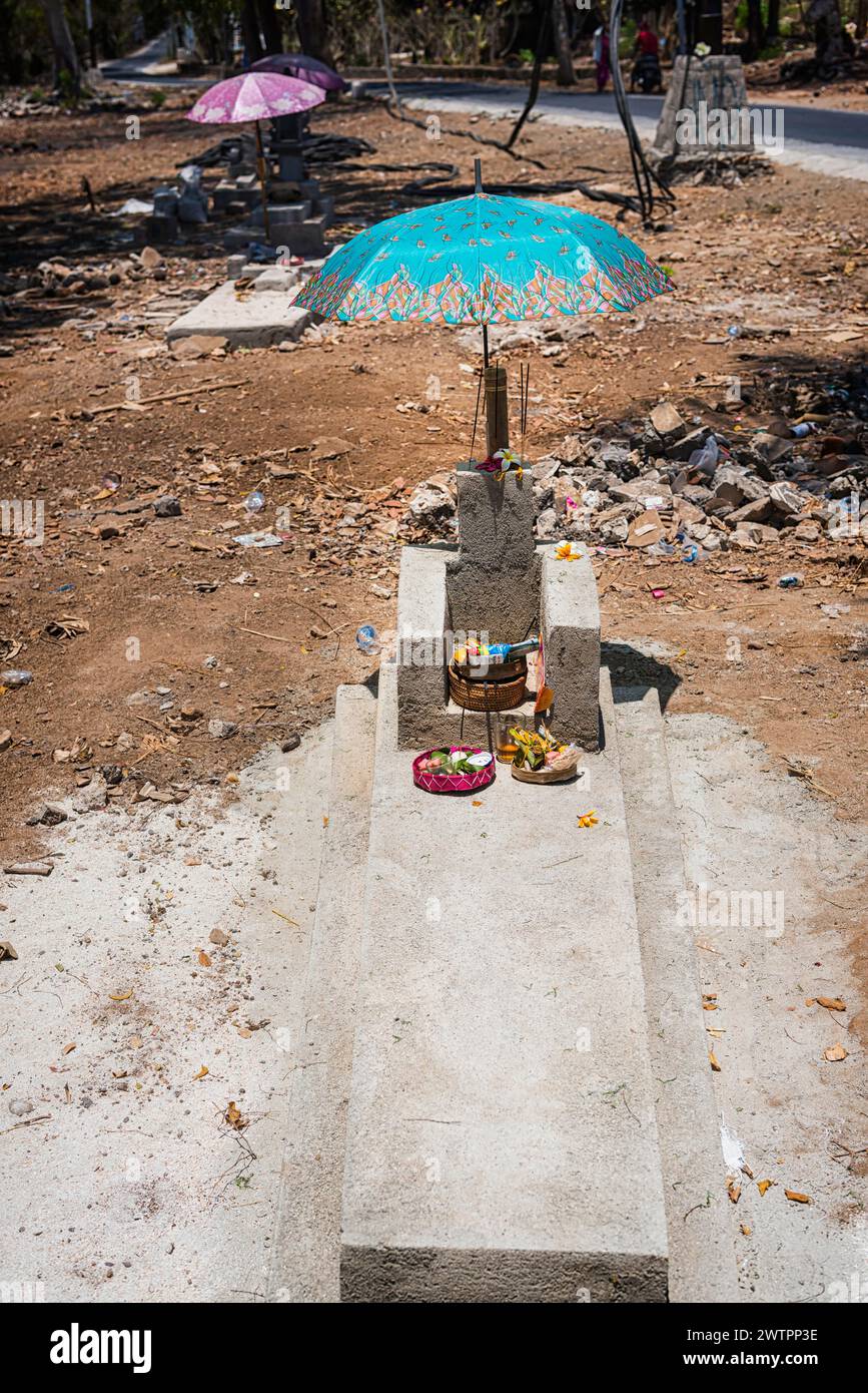 Grave in a cemetery with umbrella and offerings, Hindu, Hindu, world ...