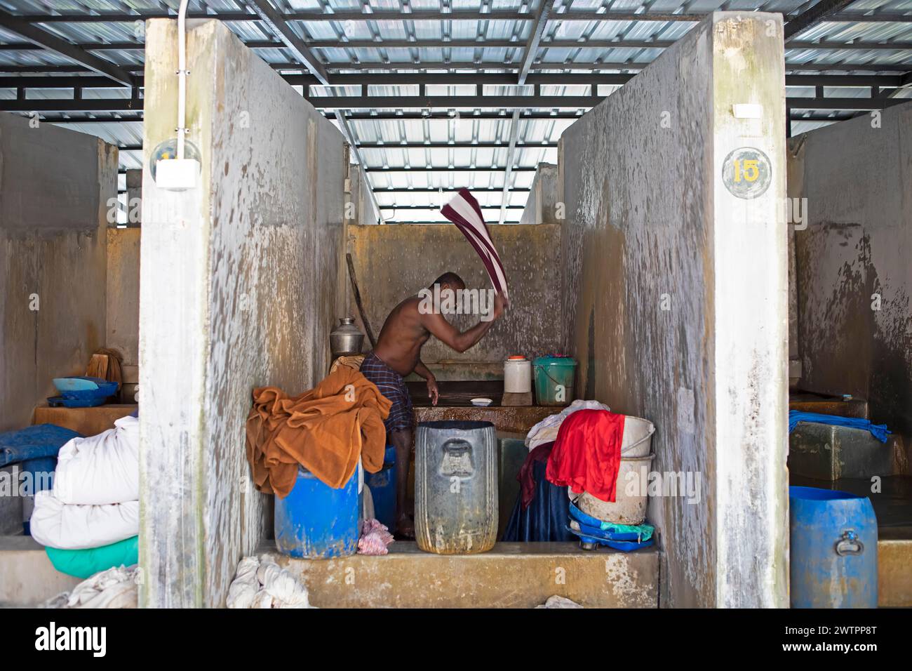 Indian man washing clothes in the laundry Dhoby Khana, Kochi, Kerala ...