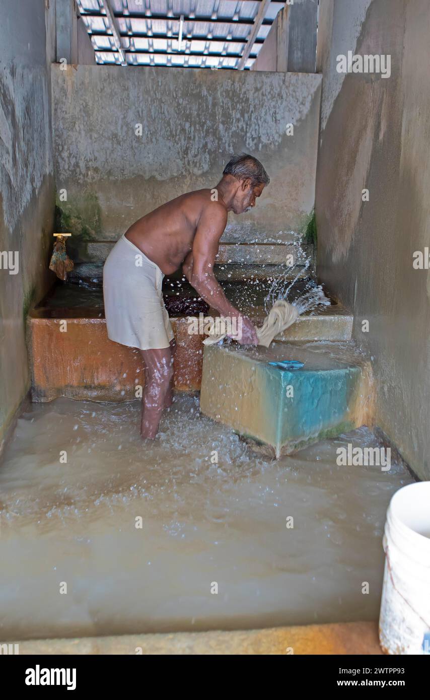 Indian man washing clothes in the laundry Dhoby Khana, Kochi, Kerala ...